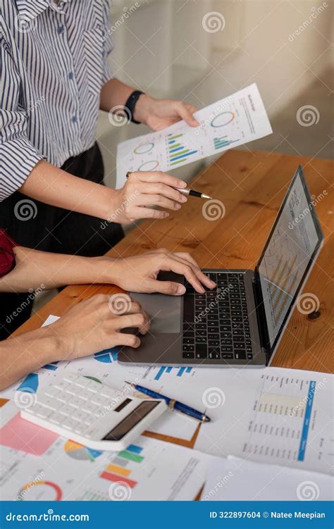 Business Team Collaboration On Data Analysis With Charts And Graph In Modern Office Setting