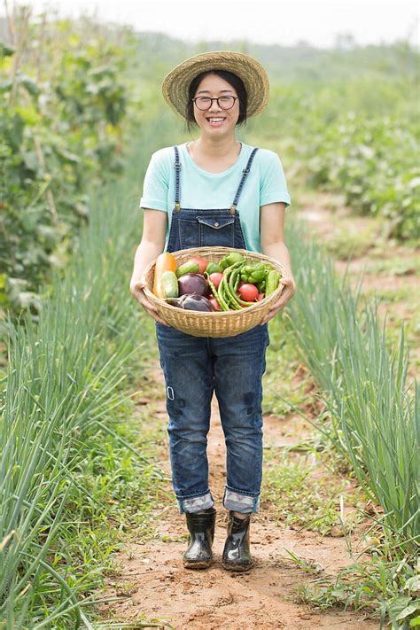 Chinese Girl Working On The Farm By Stocksy Contributor Maahoo
