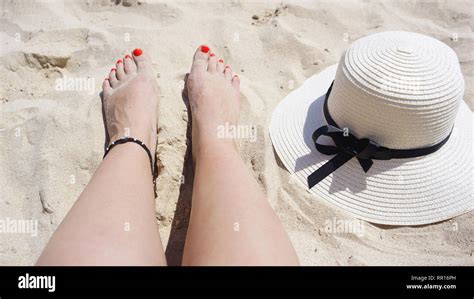 Summer Holiday Fashion Concept Tanning Woman Legs And Sun Hat At The