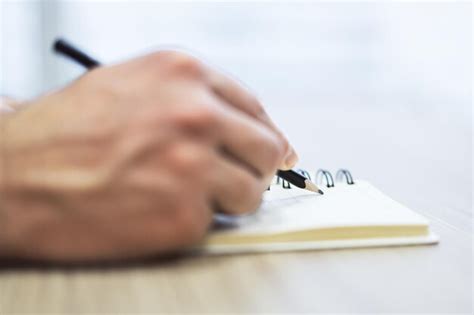 Premium Photo Closeup Of Male Hand Writing To Notepad On Blur Background