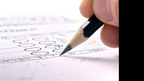 A Hand With A Pencil Filling In A Bubble Sheet For A Test Ai