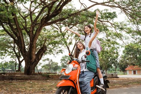 Two Naughty High School Girls Ride On A Reckless Motorbike Stock Photo Image Of Hands