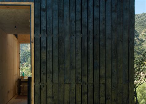 Charred Cabin By Draa Is A Blackened Timber Shelter On Stilts