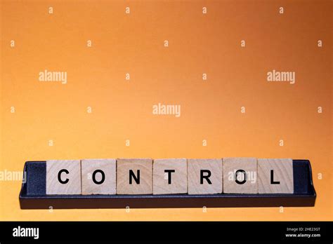 Control Word Written On Square Wooden Tiles With An Orange Background Horizontal Photography