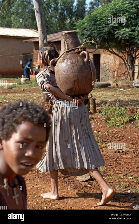 Woman Carrying Water In Pottery Jars Or Urn In Kuch Ethiopia Africa