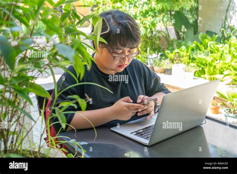 Asian Girl Typing On Smartphone Stock Photo Alamy