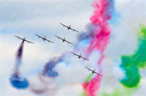 Premium Photo | Aerobatic team aircraft fighters trail of smoke in the sky.