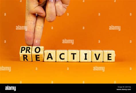 Reactive Or Proactive Symbol Businessman Turns Wooden Cubes And