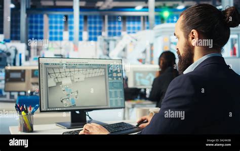 Engineer In Photovoltaics Factory Using Pc Screen To Diagnose Malfunctioning Systems Solar