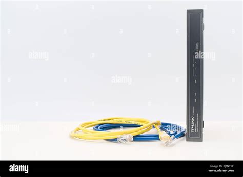 Tp Link Gigabit Broadband Network Router With Network Cables On A White Desk Stock Photo Alamy
