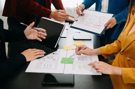 Premium Photo Ux Developer And Ui Designer Brainstorming About Mobile App Interface Wireframe