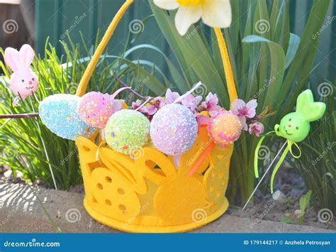Easter Decorative Eggs In The Grass With Flowers And A Basket Easter Decoration Stock Image