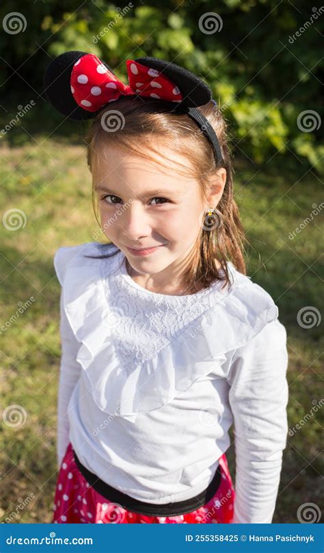 χαριτωμένο χαρούμενο κορίτσι 67 ετών με αυτιά ποντικιού στο κεφάλι της εορταστική διάθεση Στοκ