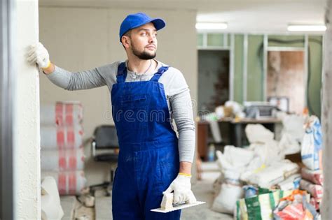 portrait of a builder in the process of working on a construction site