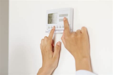 Premium Photo Unknown Woman Using Smart Home Technology Connected Appliances Device On Wall