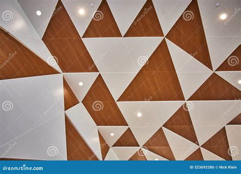 Geometric Ceiling Design With Triangular Panels And Recessed Lighting