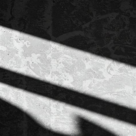 Gray Textured Surface With Diagonal Shadows Cast Across It Creating