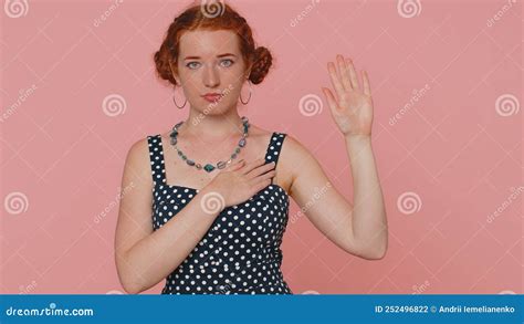 Sincere Responsible Redhead Woman Raising Hand To Take Oath Promising