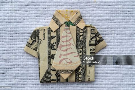 흰색 직물 배경에 달러 지폐로 만든 종이 접기 셔츠 근접 촬영 달러 빌 티셔츠 T 셔츠에 대한 스톡 사진 및 기타 이미지 T 셔츠 개념 개념과 주제 Istock