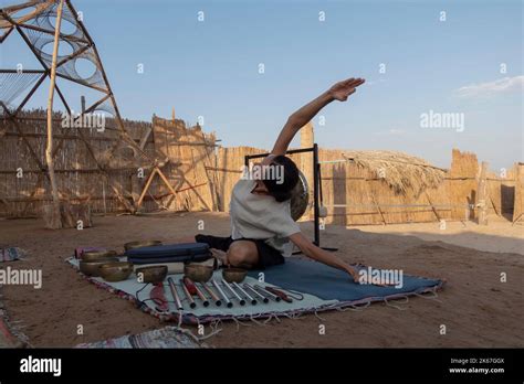 a woman practices yoga in ras el satan or ras shaitan beach resort area