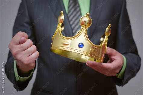 Businessman King Holding In Hands A Gold Crown And Showing A Fig