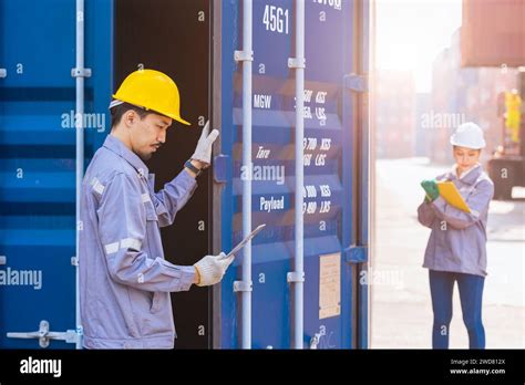 Asian Man And Women Team Workers Customs Staff Teamwork In Container Yard Port Shipping Cargo