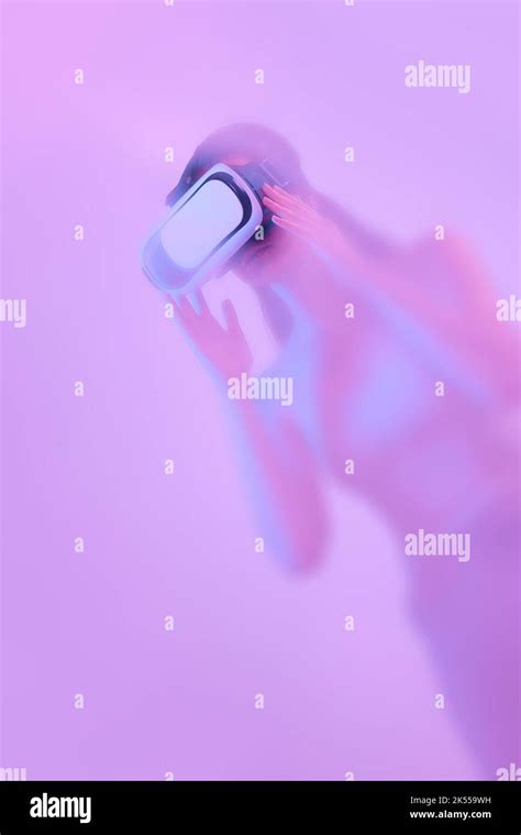 Female Model In Virtual Reality Glasses Immersed In Clouds Of Smoke Fog On A Pink Neon
