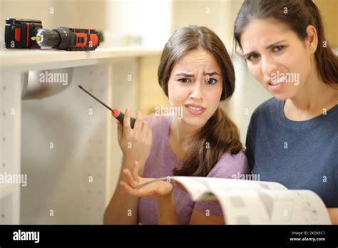 Confused Roommates Holding Installation Manual Looking At You Reforming House Stock Photo Alamy