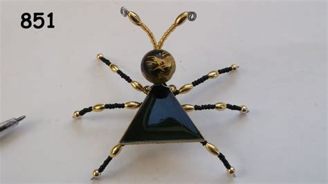 No 851 A Triangular Beadbug With A Tigers Eye Head Engraved With A Dragon Wire And Bead