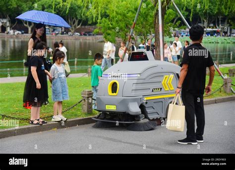 An Intelligent Sweeping Robot Works At The Bai Causeway In The West Lake Scenic Spot Drawing