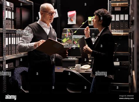 Private Detectives Analyzing Criminal Investigations Report Working Overtime At Solution To