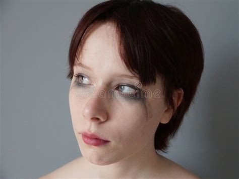 Portrait Of A Sad Teenage Girl With Short Brown Hair And Tearful Eyes