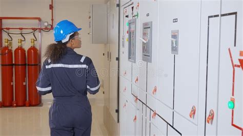 Electrical Young Asian Woman Engineer Examining Maintenance Cabinet System Electric And Using