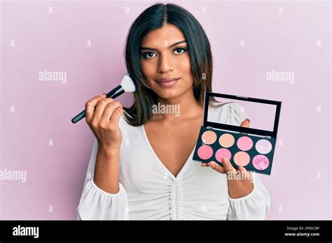 Young Latin Transsexual Transgender Woman Holding Makeup Brush And