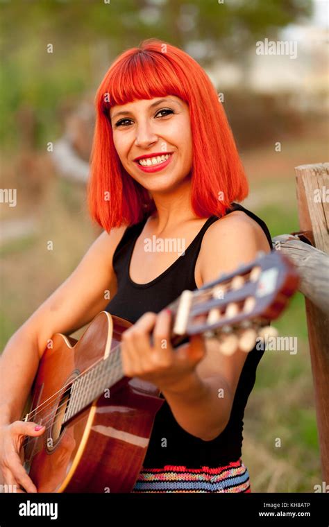 Red Hair Woman Playing Guitar In The Countryside Stock Photo Alamy