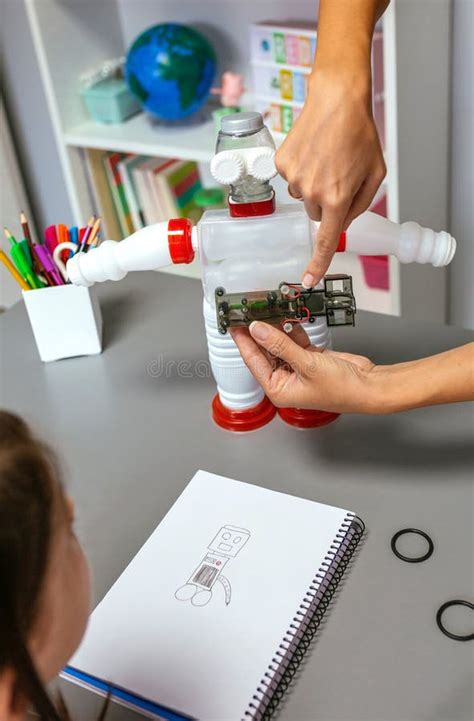 Teacher Explaining How To Connect Electric Circuit On Recycled Toy Robot Stock Image Image Of