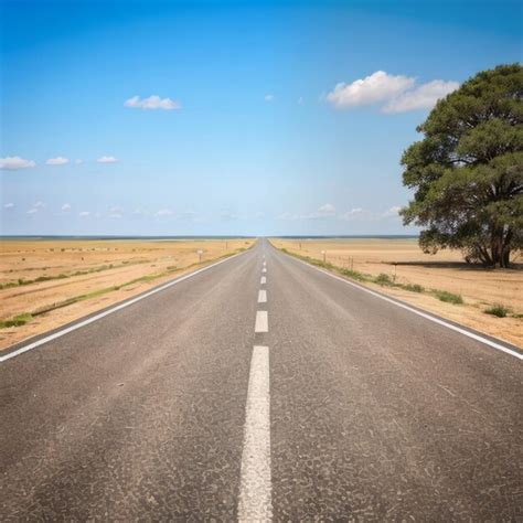 Premium Photo A Long Straight Road And Blue Sky