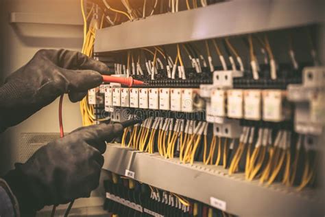 Close Up Hand Of Electrical Engineer Using Measuring Equipment To Checking Electric Current