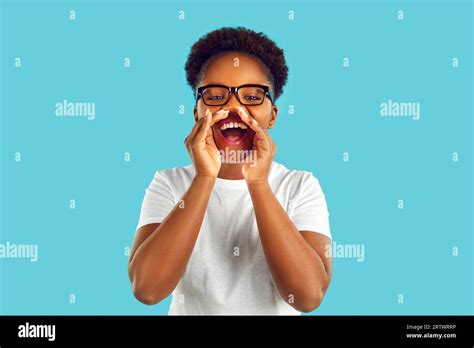 Funny Woman Holds Her Hands Near Her Open Mouth And Speaks Loudly