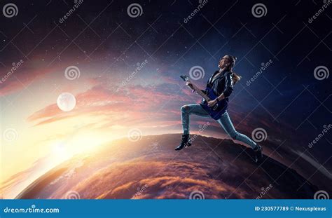 Young And Beautiful Rock Girl Playing The Electric Guitar Stock Image