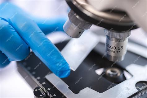 Premium Photo Scientist Analyzing Microscope Slide At Laboratory Young Woman Technician Is