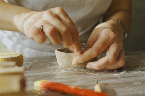 A Woman Makes Holes Using A Tool In A Clay Craft A Candlestick Stock Photo Image Of