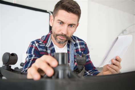 Man Following Instructions To Assemble Office Chair Stock Image Image Of Handyman Fasten