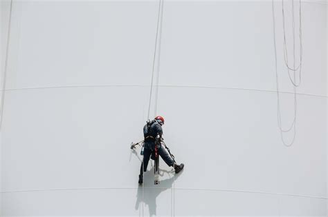 Premium Photo Male Workers Control Swing Rope Down Height Tank Rope Access Inspection Of