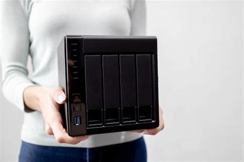 Premium Photo Female Holds Small Nas Backup Server Data Backup And Security Concept
