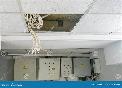 Interweaving Of Electrical Wires Hangs From A Broken Suspended Ceiling