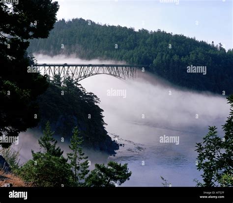 Fog Drifts Under The Deception Pass Bridge At Deception Pass State Park