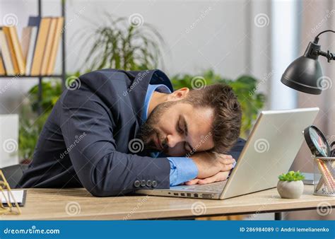 bored sleepy caucasian business man worker working on laptop computer