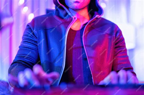 Premium Photo Hacker Wearing Hood Jacket Typing Computer Keyboard To