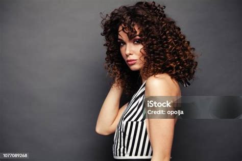 패션 모델 소녀 회색 배경 위에 절연입니다 뷰티 스튜디오에 유행 옷을 입고 포즈를 취하는 세련 된 갈색 머리 여자 캐주얼 스타일 뷰티 액세서리입니다 높은 패션 도시 스타일